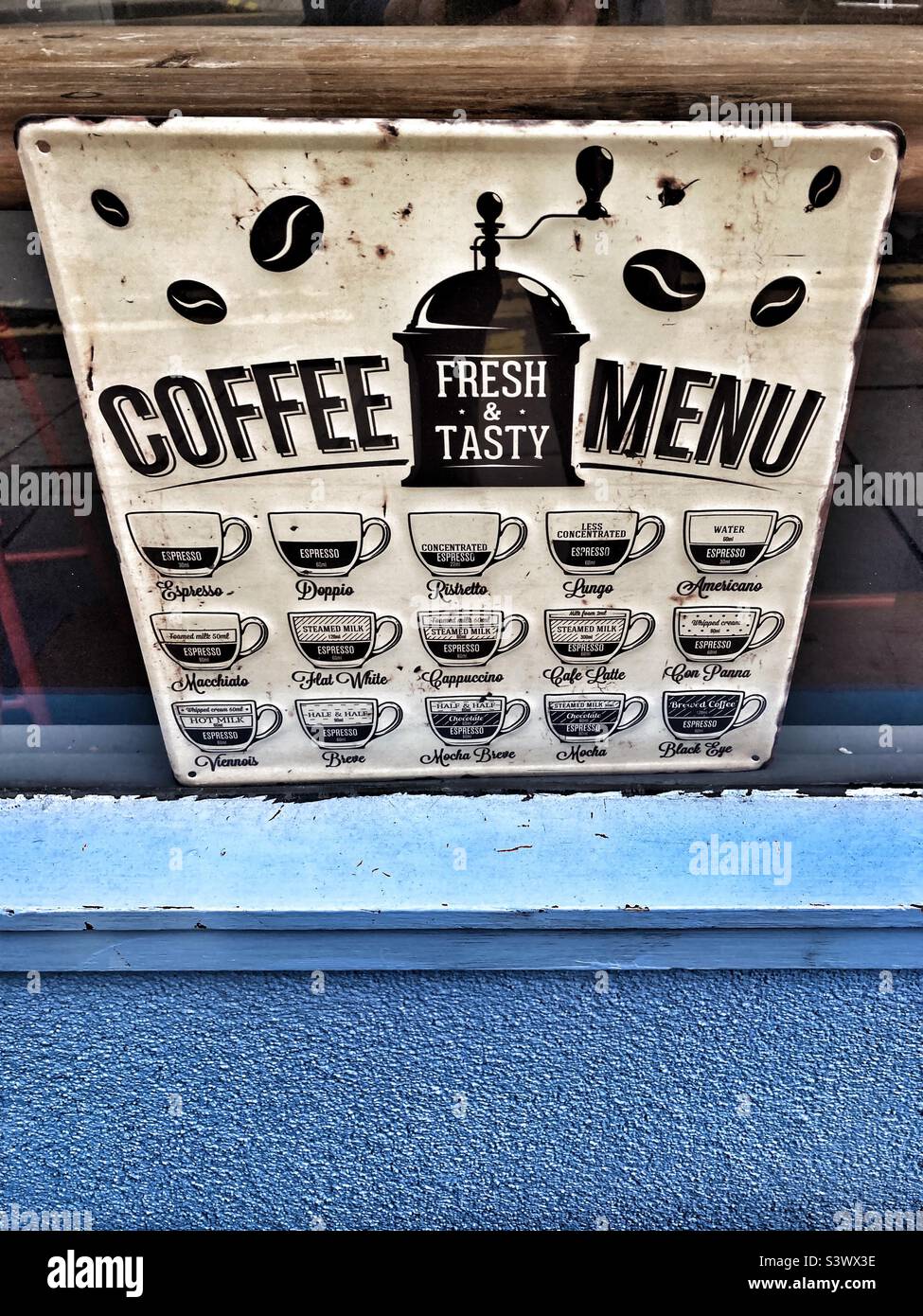 Coffee menu in cafe window Stock Photo - Alamy