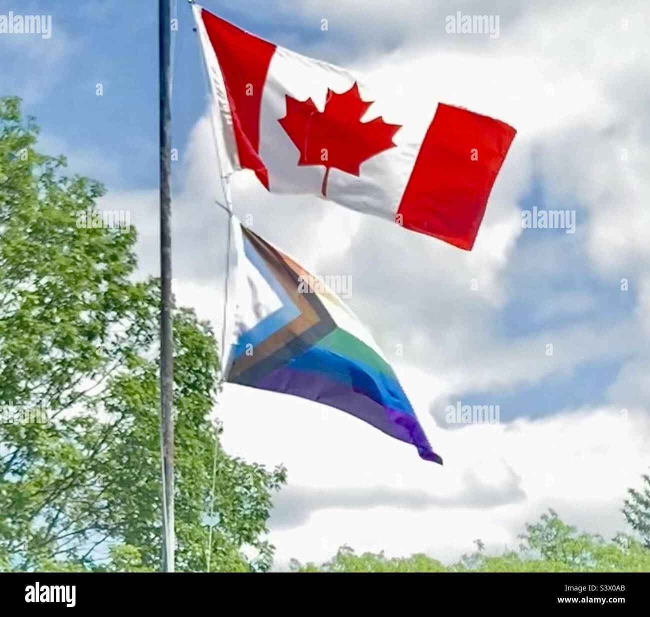 The Canadian flag joined by the Pride flag Stock Photo - Alamy