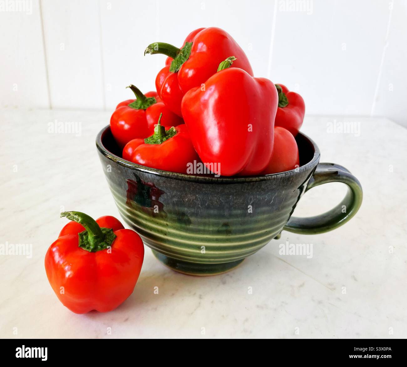 Little red peppers in a pottery mug Stock Photo - Alamy