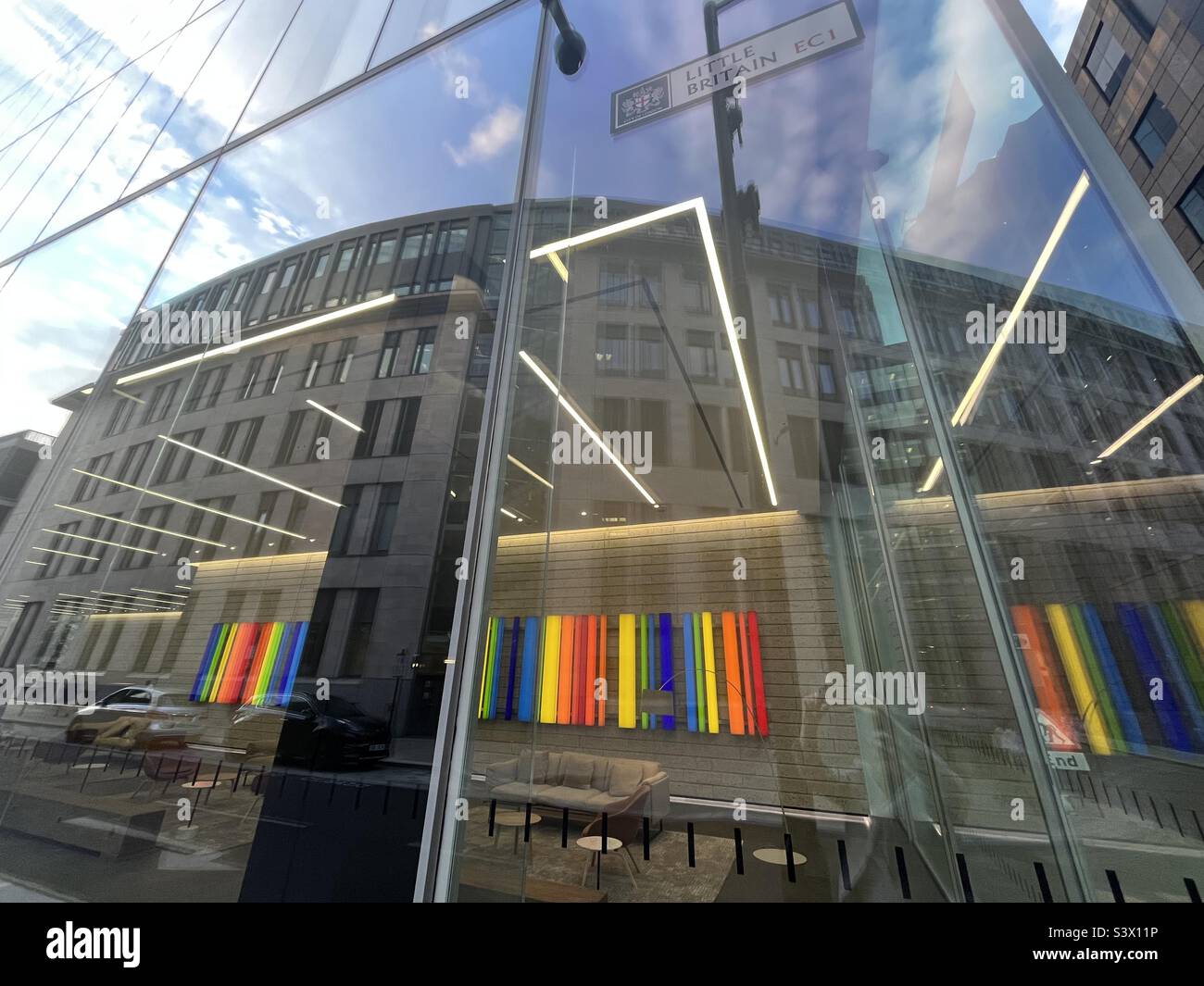Reflections on an office building’s windows in Little Britain a small ...