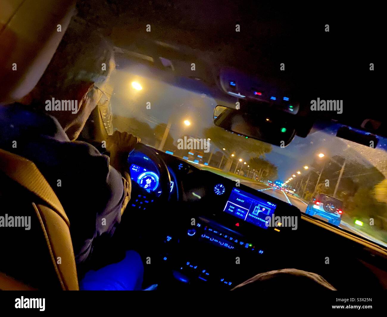 Night driver-man driving shot from inside of his automobile Stock Photo ...