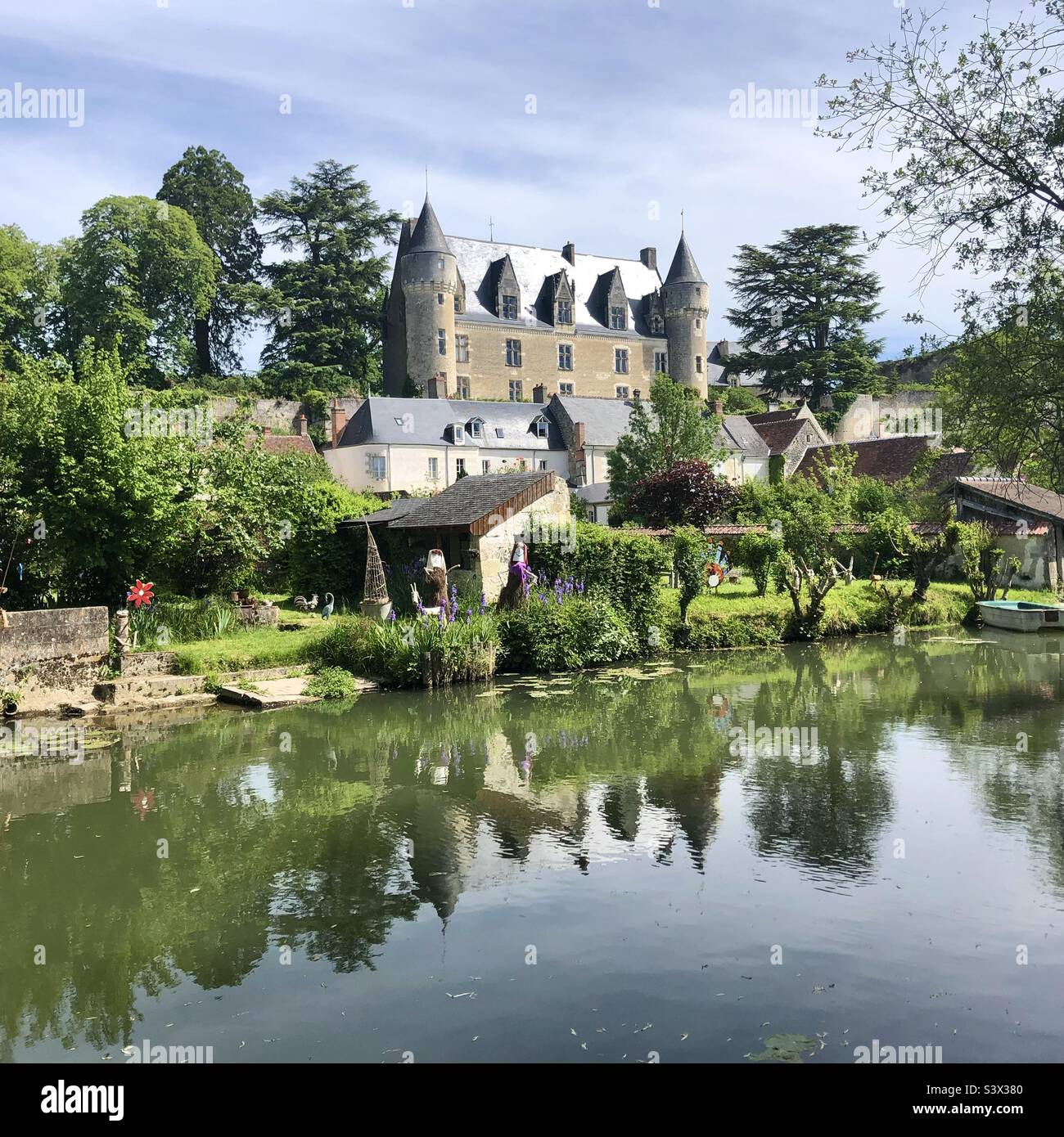 A summers day in Montrésore, France. A gently ambling river flows ...