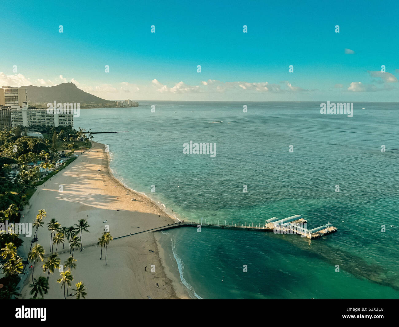 Areal view of Waikiki shoreline with sandy beach nearly empty, in the ...