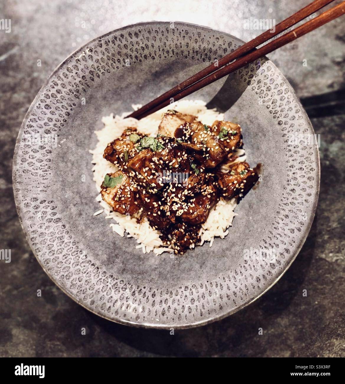 Tuna fish in a sticky honey glaze sauce, sprinkled with sesame seeds on ...