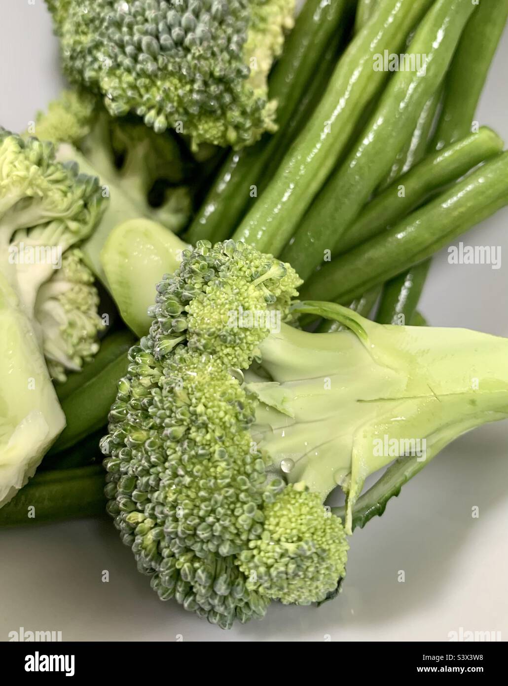 Raw vegetables Green broccoli and beans Stock Photo - Alamy