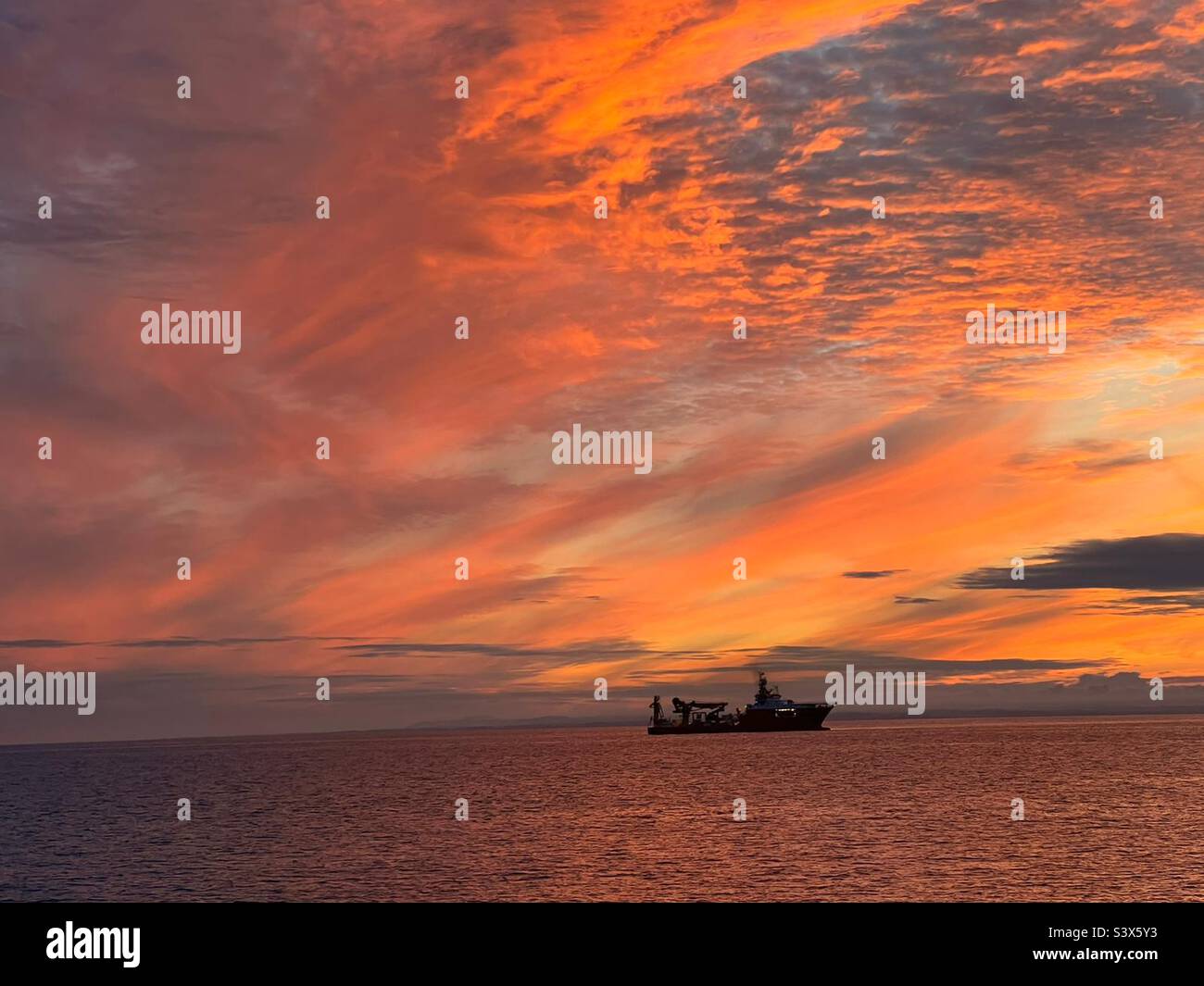 Red Sky Offshore Stock Photo - Alamy