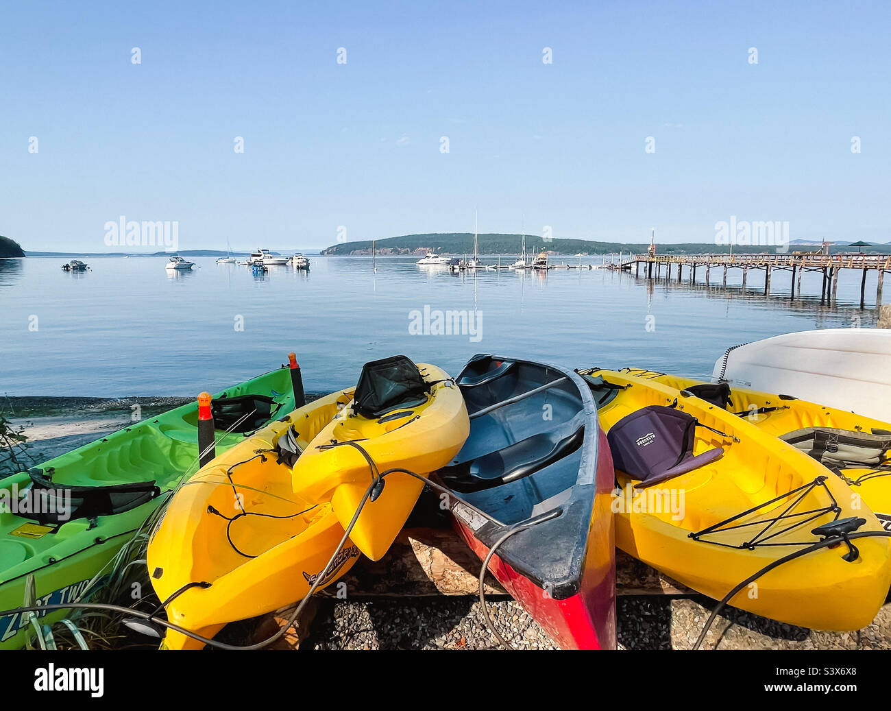 Colorful canoes stack up by the shore at Orcas Island, Washington, USA ...