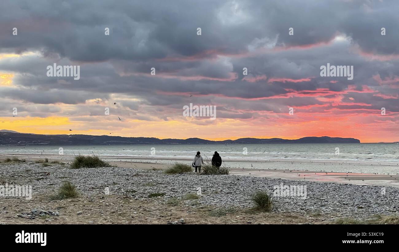 Beautiful orange and red sunset over a beach Stock Photo - Alamy