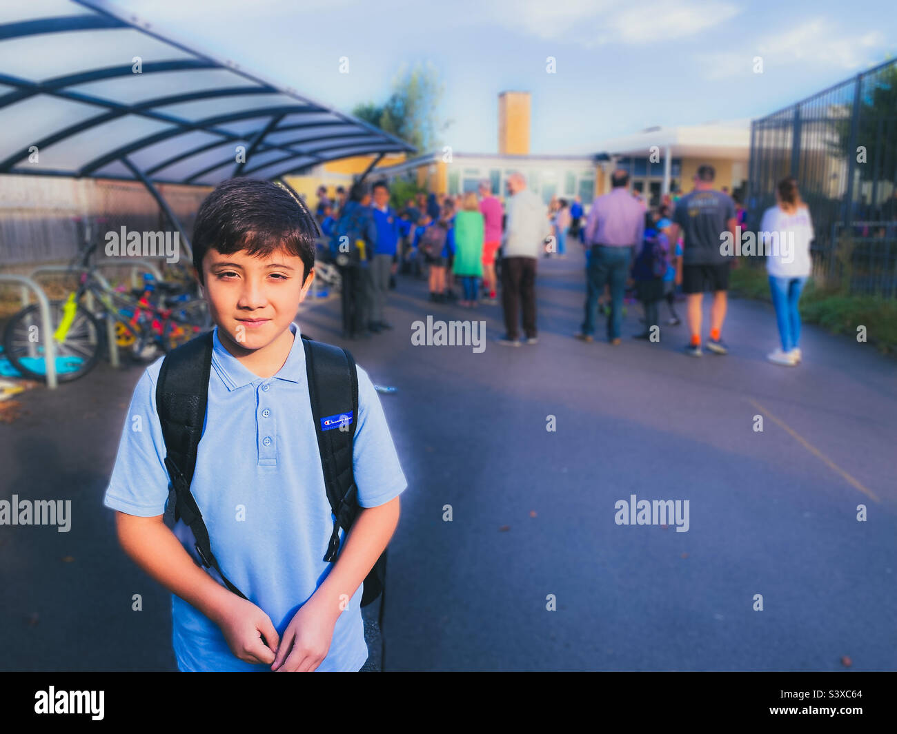 A boy arriving back at school for the first day of the new school year ...