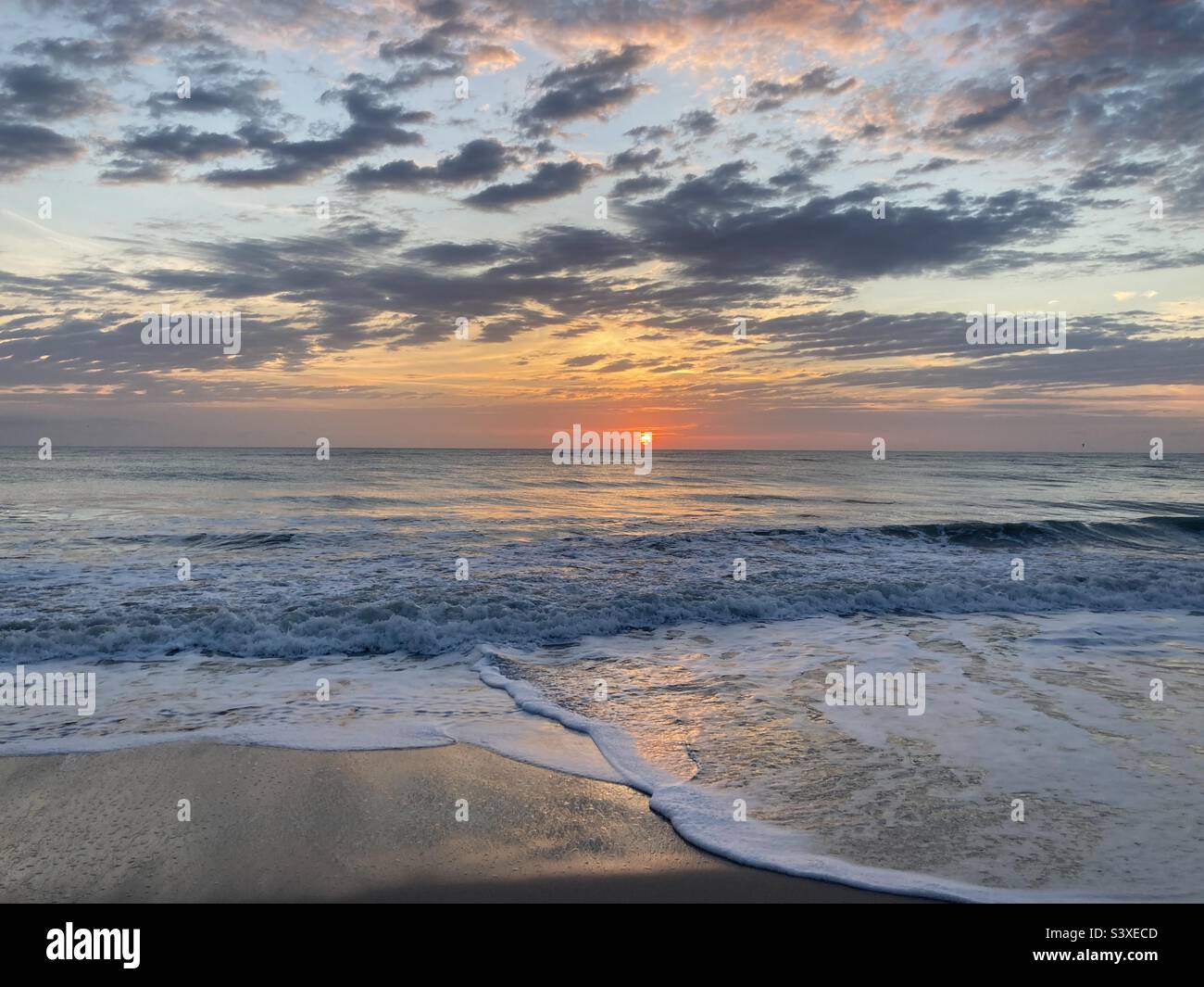 Blue sky with clouds over ocean waves with sand hi-res stock ...