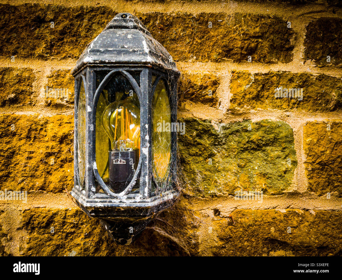 Weathered lantern mounted on stonewall Stock Photo - Alamy