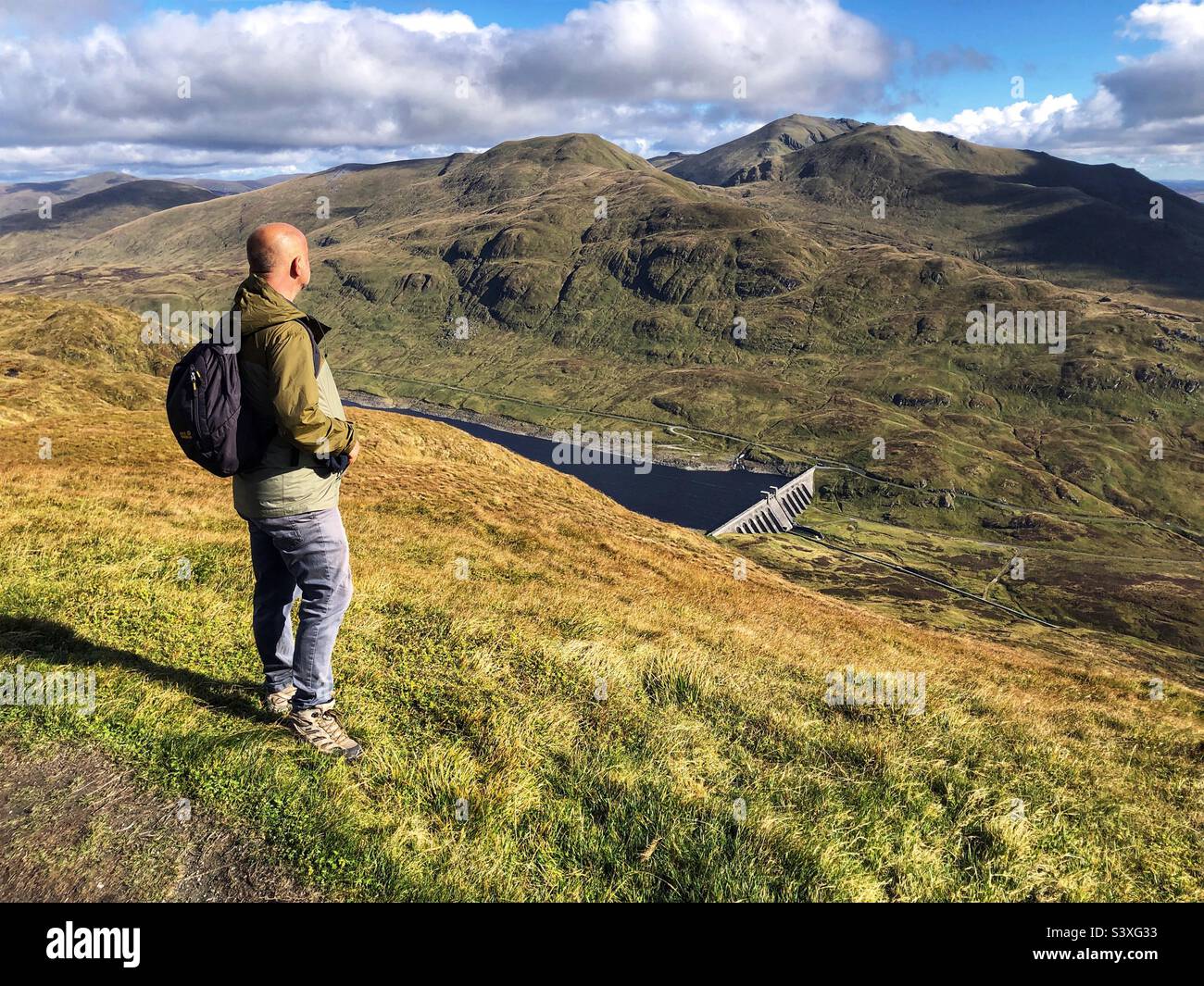 Walker on the path up towards the Tarmachan ridge with a view of the ...