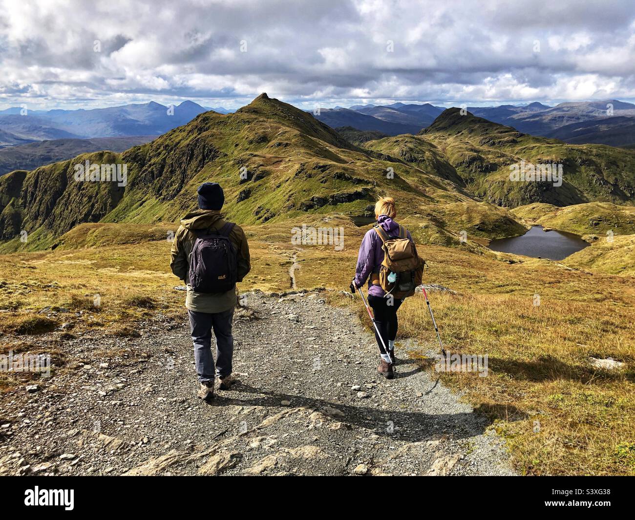 Walkers on the path of the Tarmachan ridge, with a view of the ...