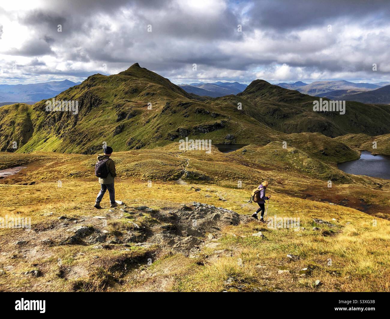 Walkers on the path of the Tarmachan ridge, with a view of the ...