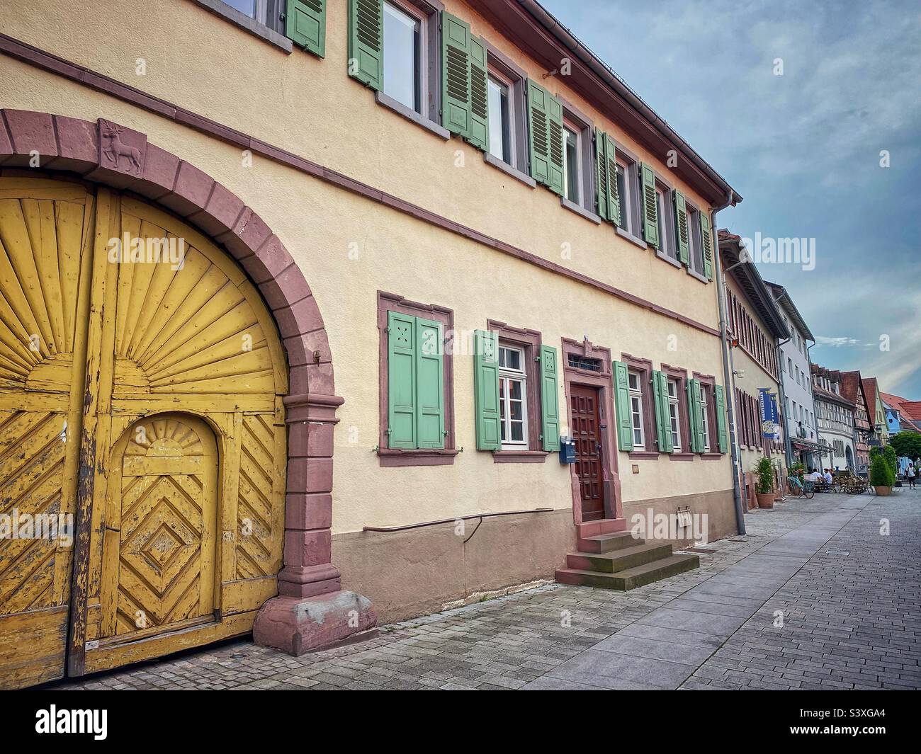 Old building with traditional door and window shades in the center of ...