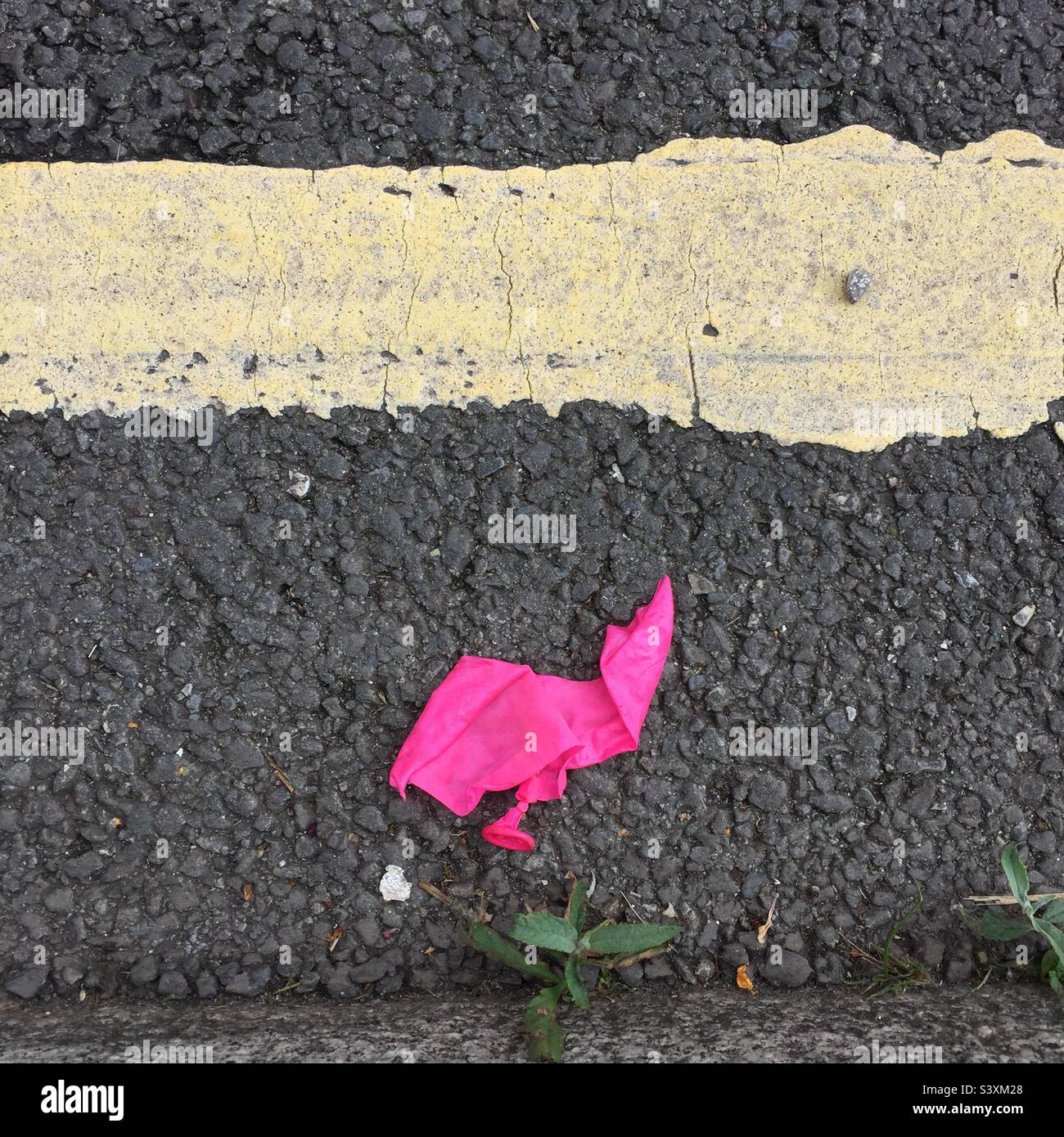 Burst balloon on roadside Stock Photo - Alamy