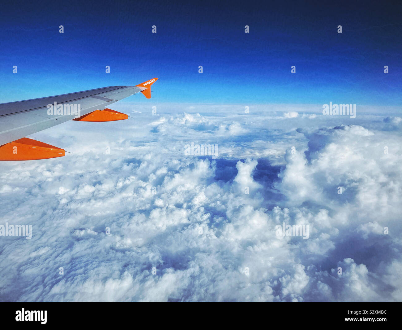 The view out the window of an easyJet aircraft as it flies high above ...