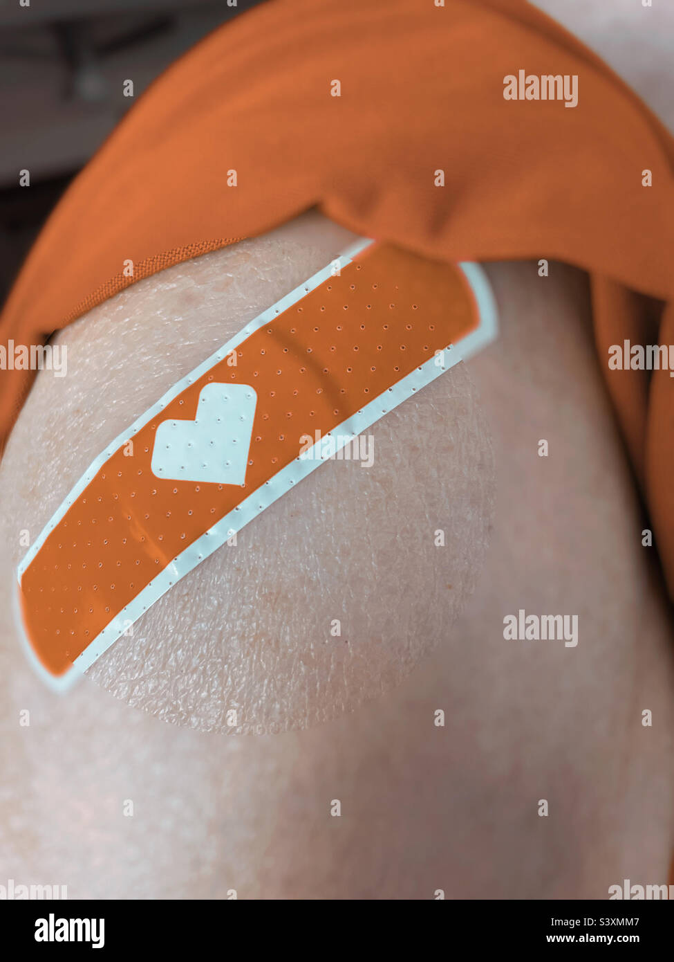 Band-Aid on the upper arm of a recently vaccinated Caucasian male, 2022 ...