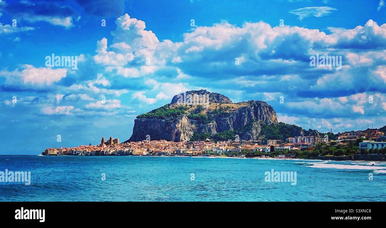 The seafront town of Cefalu in Sicily with e the rock and cathedral ...
