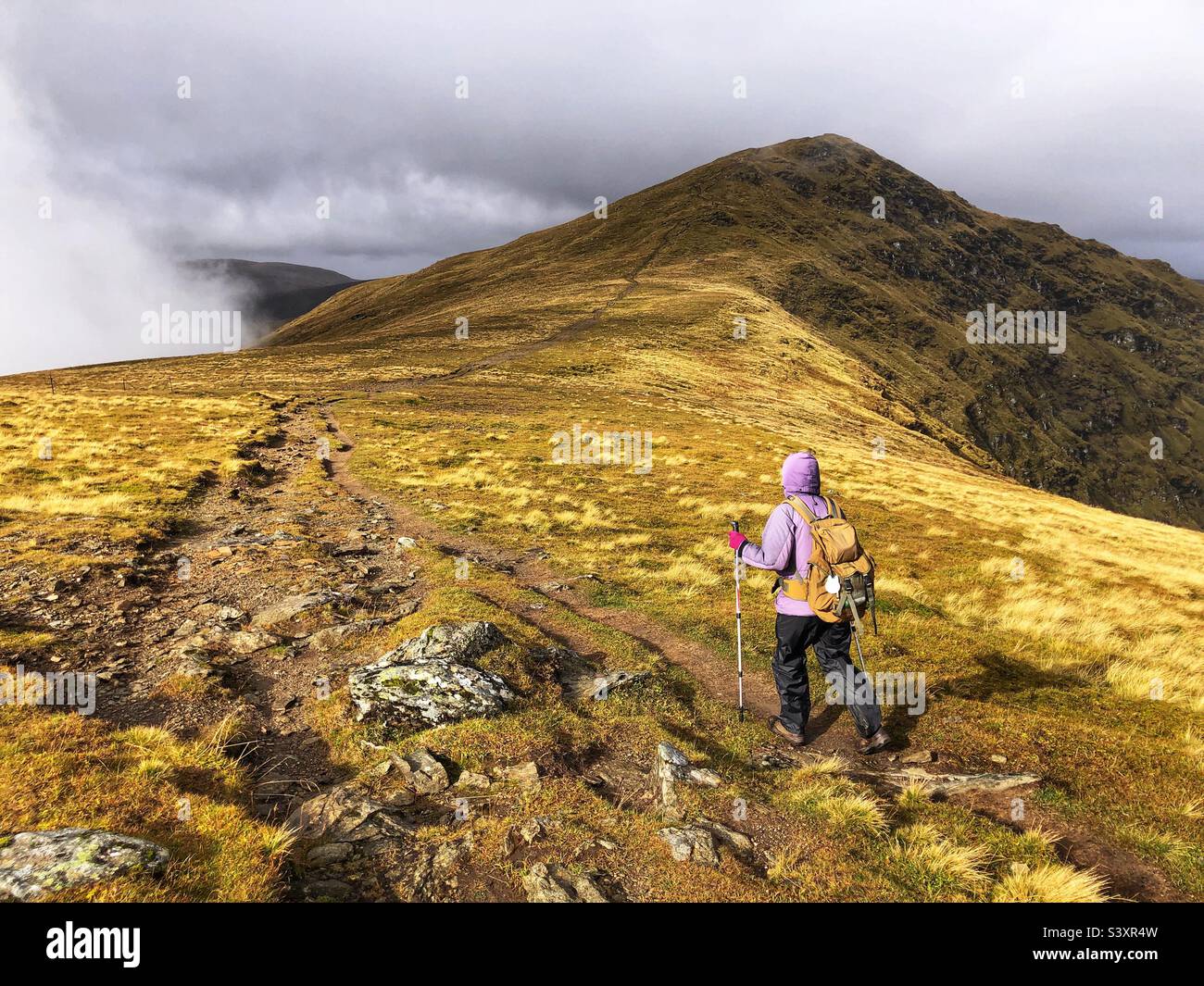 Female Walker on the path approaching the summit of Munro Stuc an ...