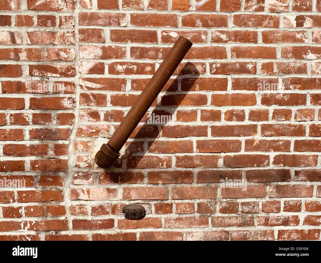 Pipe on brick wall, background / close up Stock Photo - Alamy
