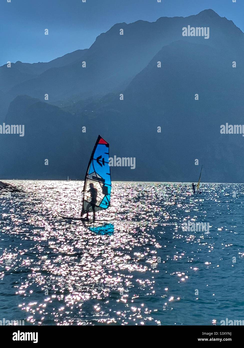 Wind sailing on lake Garda at sunset Stock Photo - Alamy