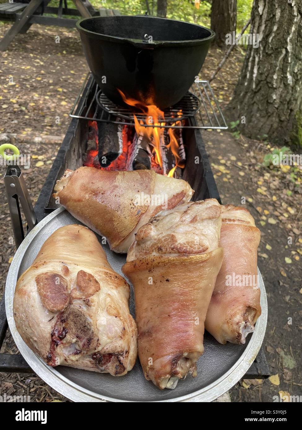 pork knuckles, cooking in a cauldron over a fire Stock Photo - Alamy