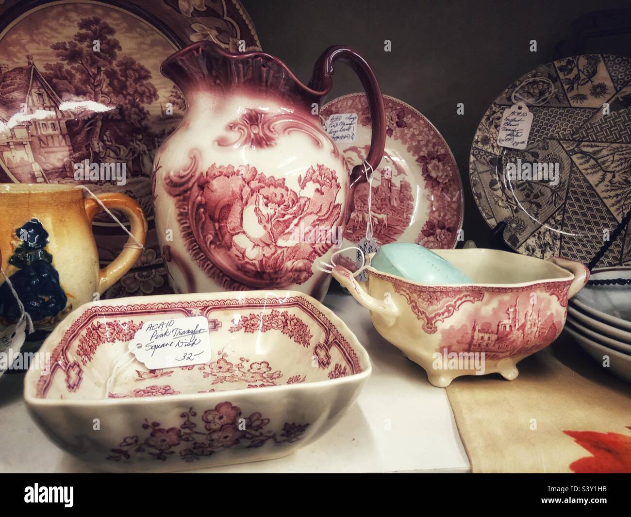 Red transferware pottery on display at antique mall Stock Photo - Alamy