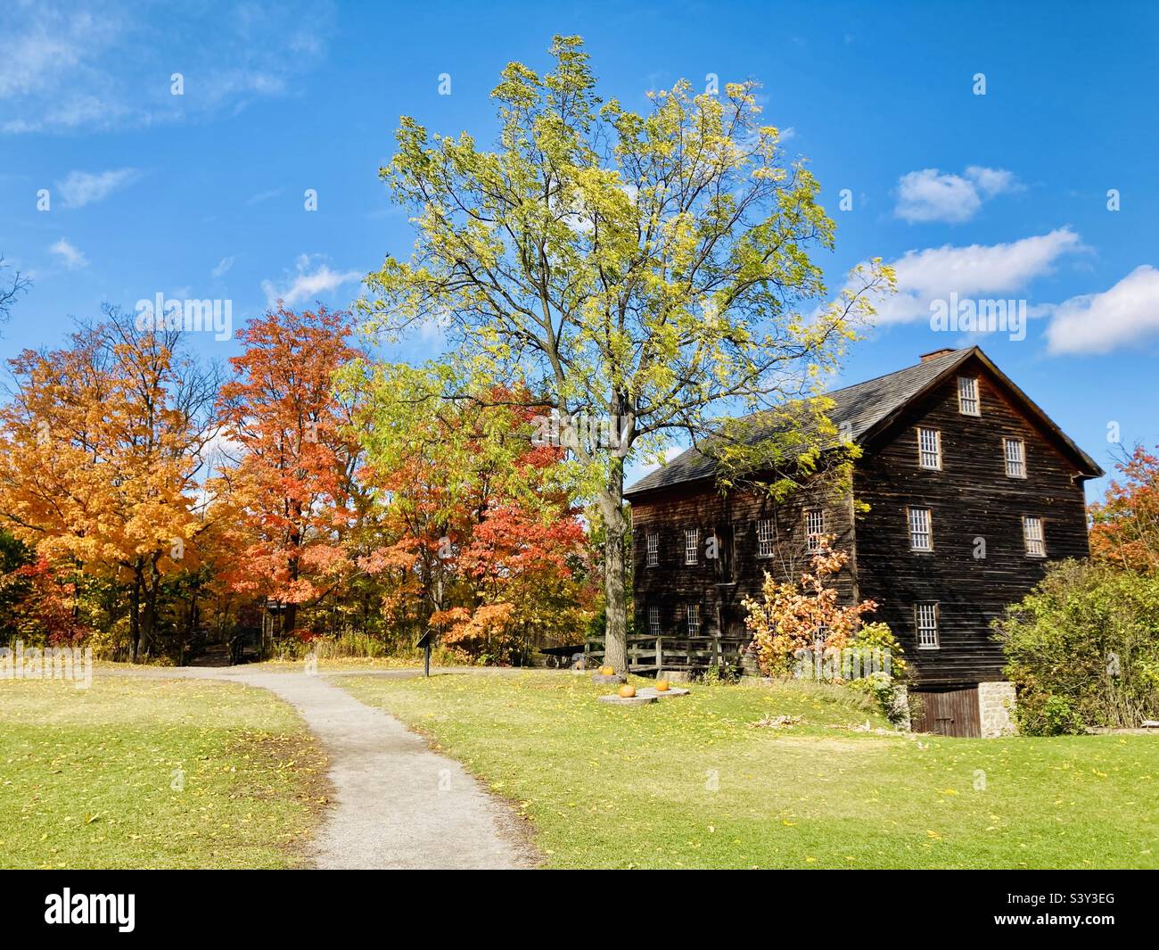 Classic Fall scene, an old mill at surrounded by colourful Autumn ...