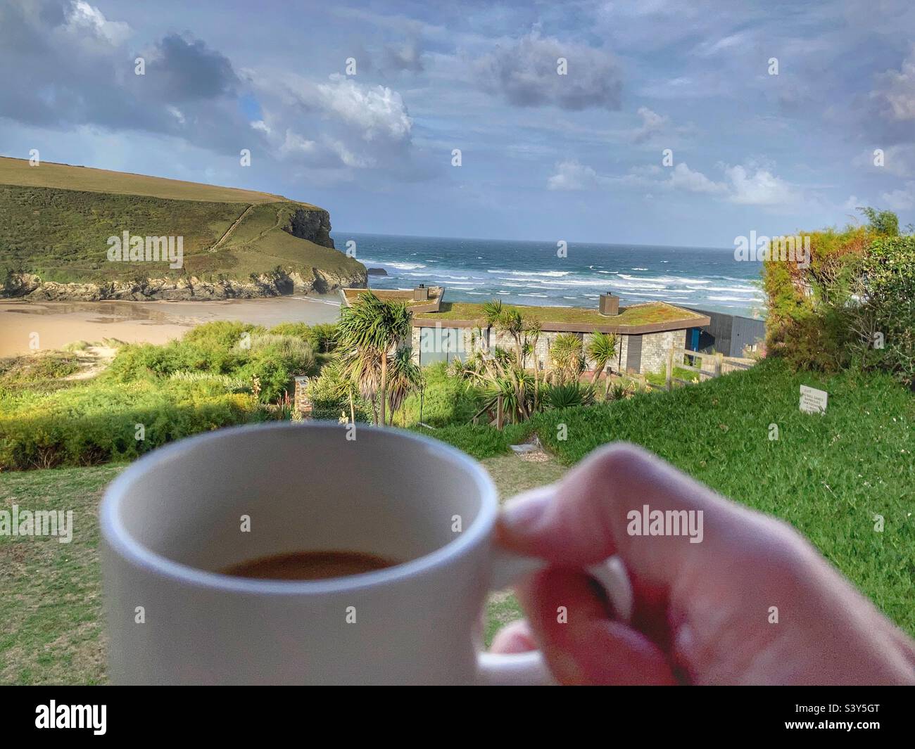 Cup of coffee with a view of Mawgan Porth Cornwall Stock Photo - Alamy