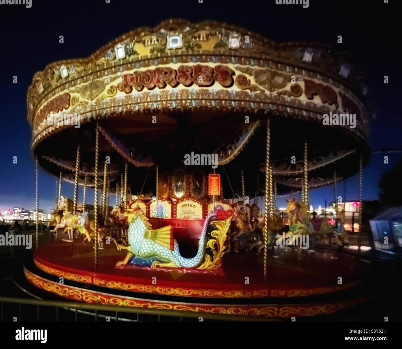 Fairground Carousel deserted at night by the Greenwich riverside Stock ...