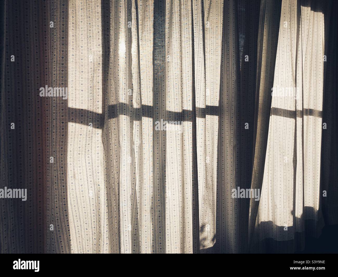Sheer Curtains With Sunlight Shining Through The Lattice Window Behind