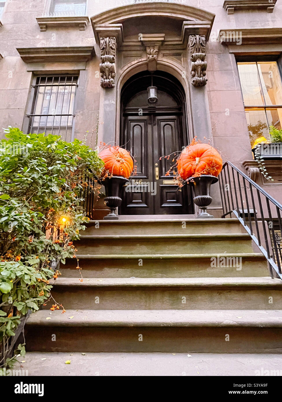 The front door and stair case of a historic brownstone in the Murray ...