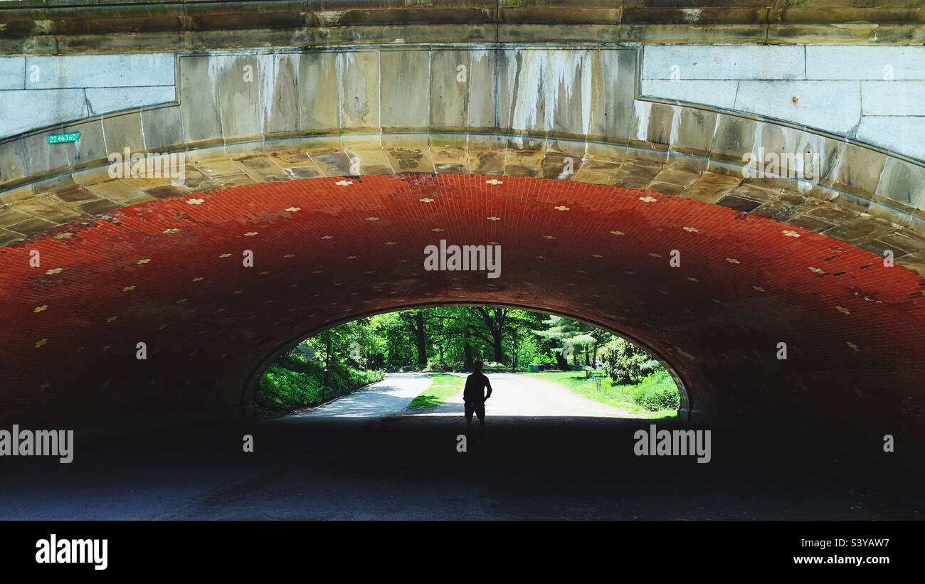 A man standing under the bridge Stock Photo - Alamy