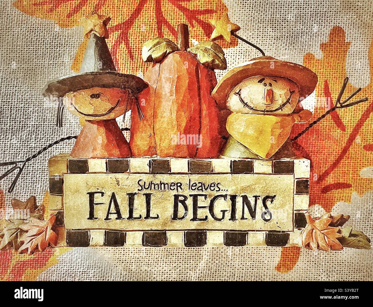 Seasonal home decor laid upon a fall leaf designed cloth on a living ...