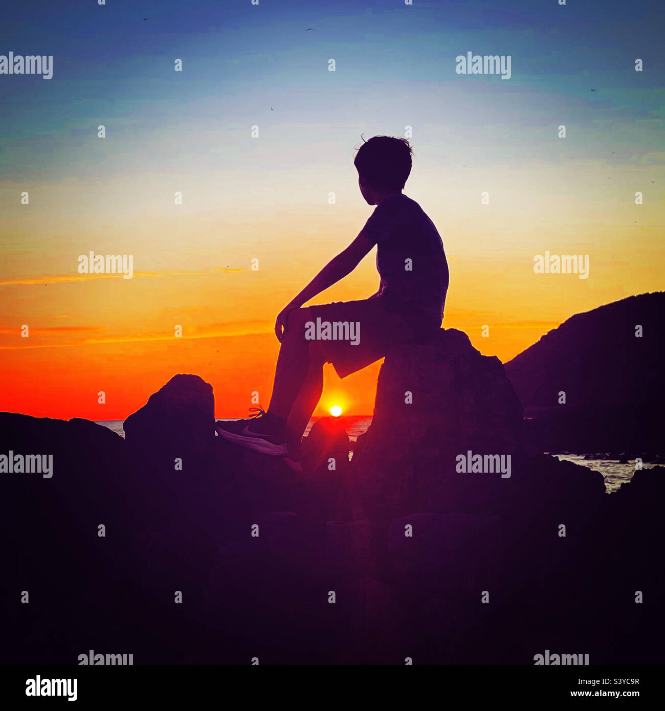 Boy looking at sunset hi-res stock photography and images - Alamy