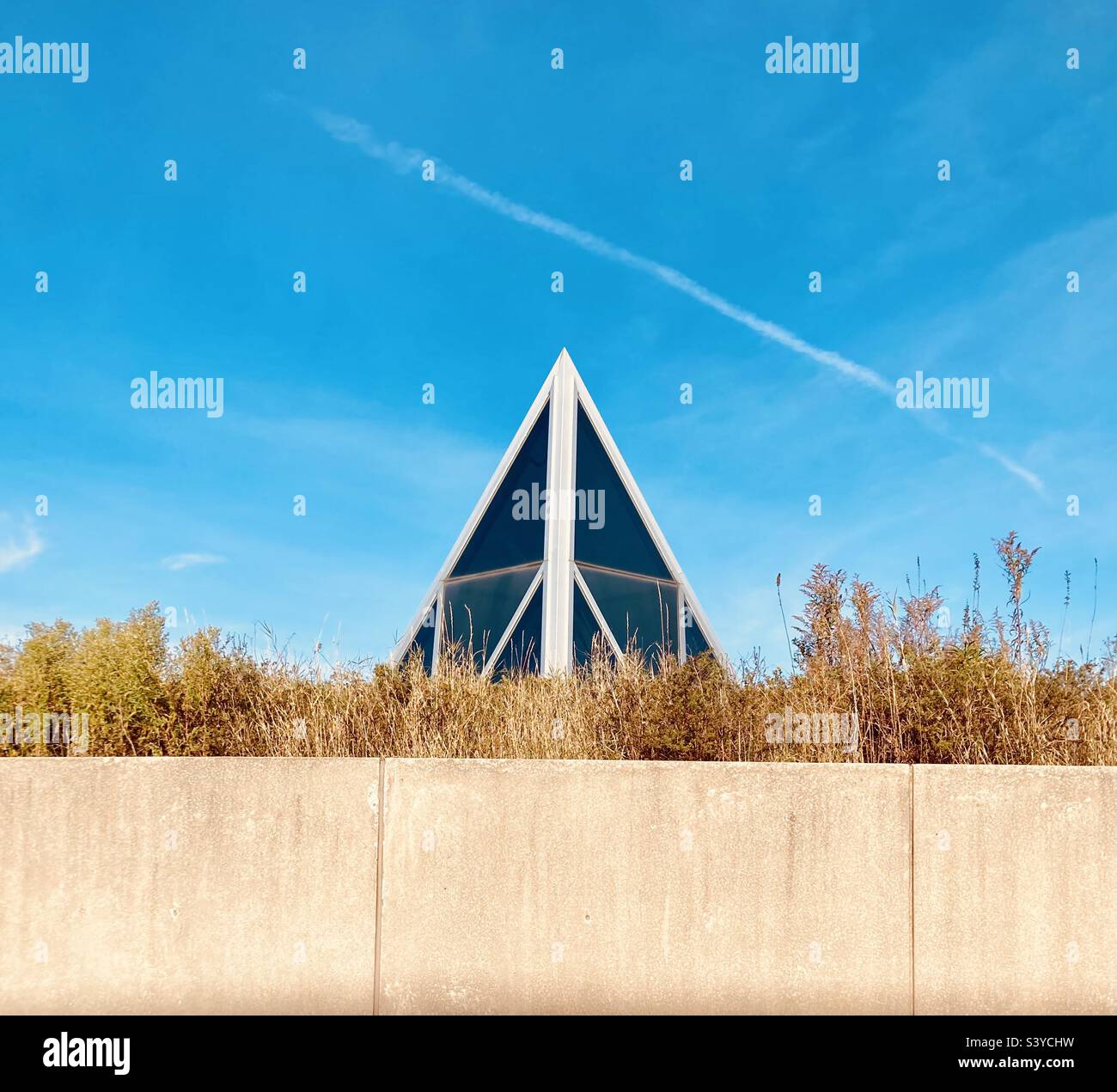 Triangular architecture jutting out from the earth Stock Photo - Alamy