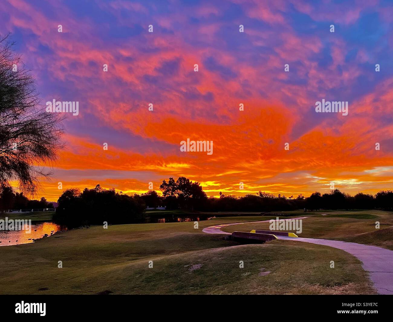 Arizona sunrise with golden colors brighter than the flag reflected in ...