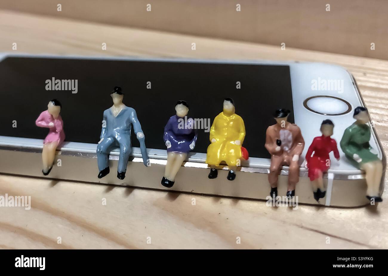 People on the phone - miniature figures sitting on an iPhone Stock ...