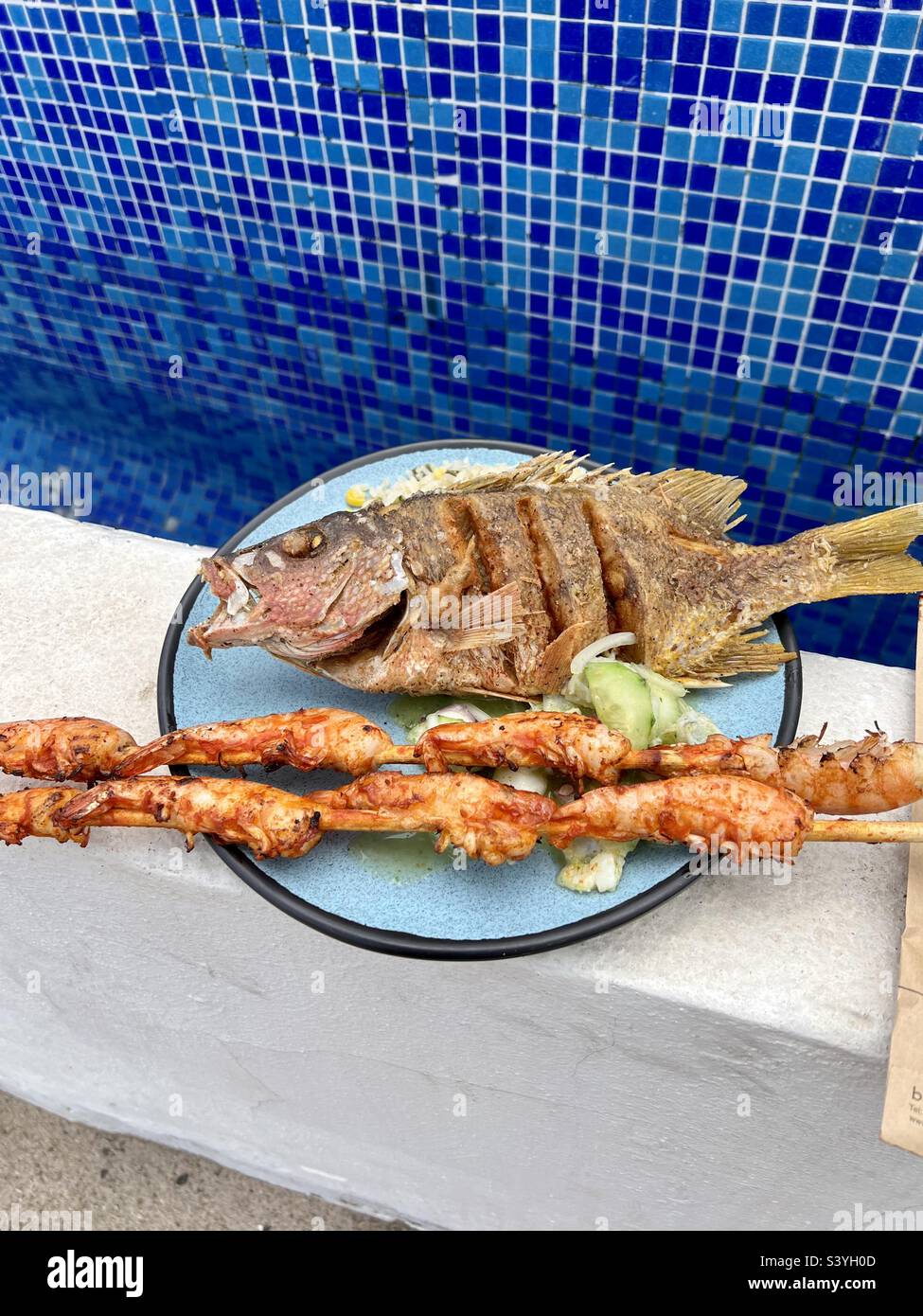Plate of fresh caught Fried fish and shrimp at a beach party in Puerto ...