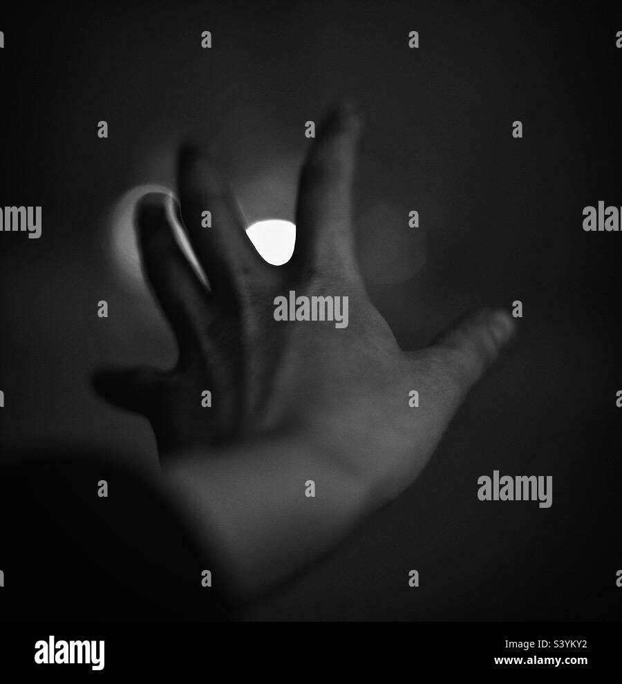 Hand reaching out for the light Stock Photo - Alamy