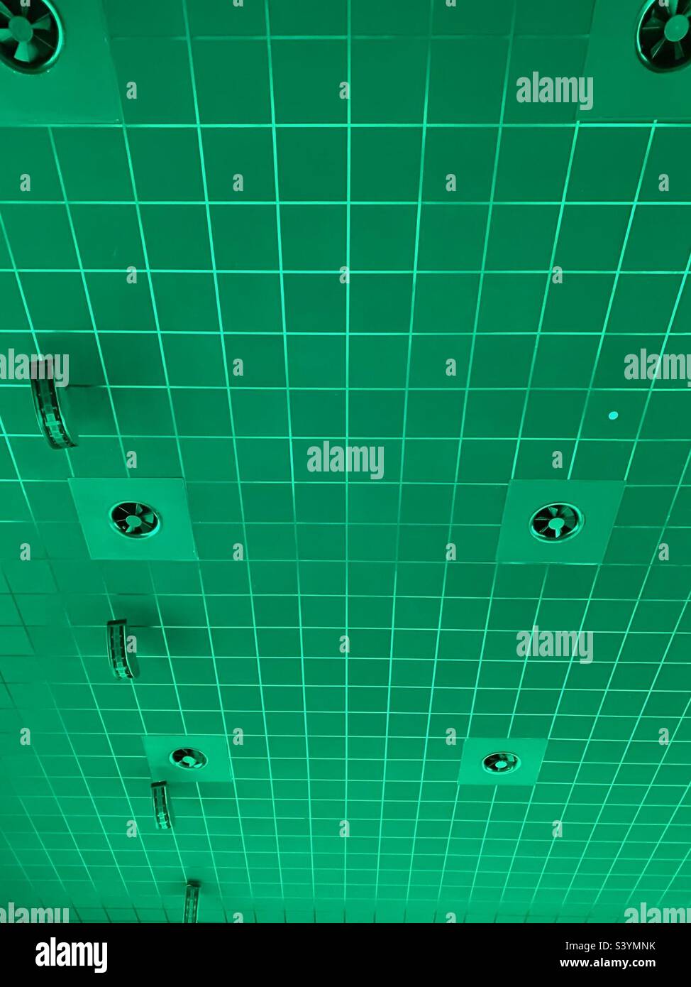 Green-lit futuristic grid ceiling Stock Photo - Alamy
