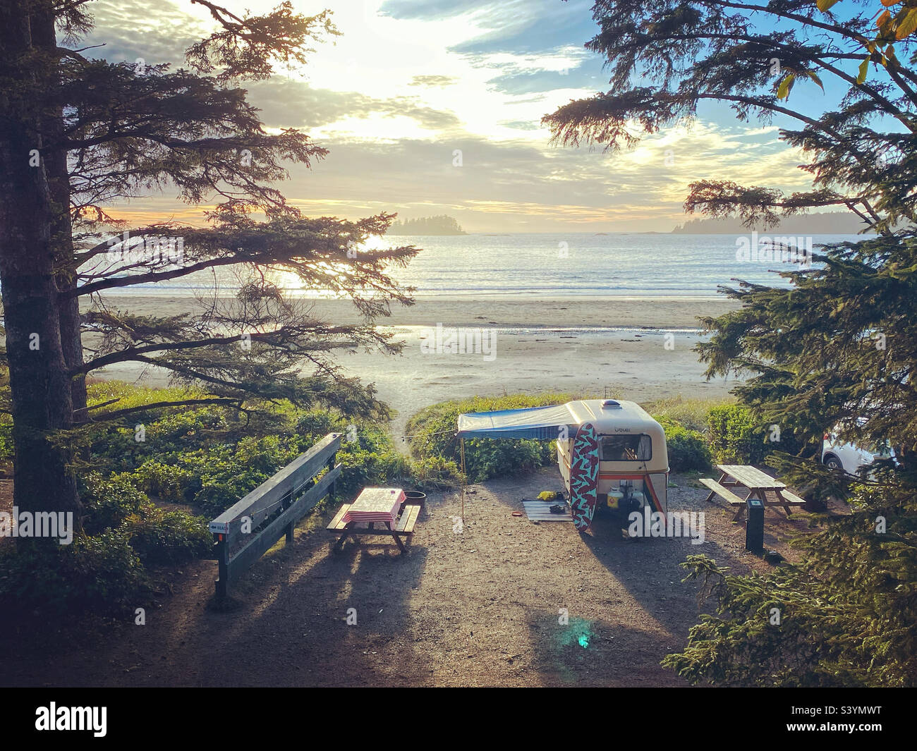 Retro trailer at a beachfront campsite in Tofino BC with a surfboard ...