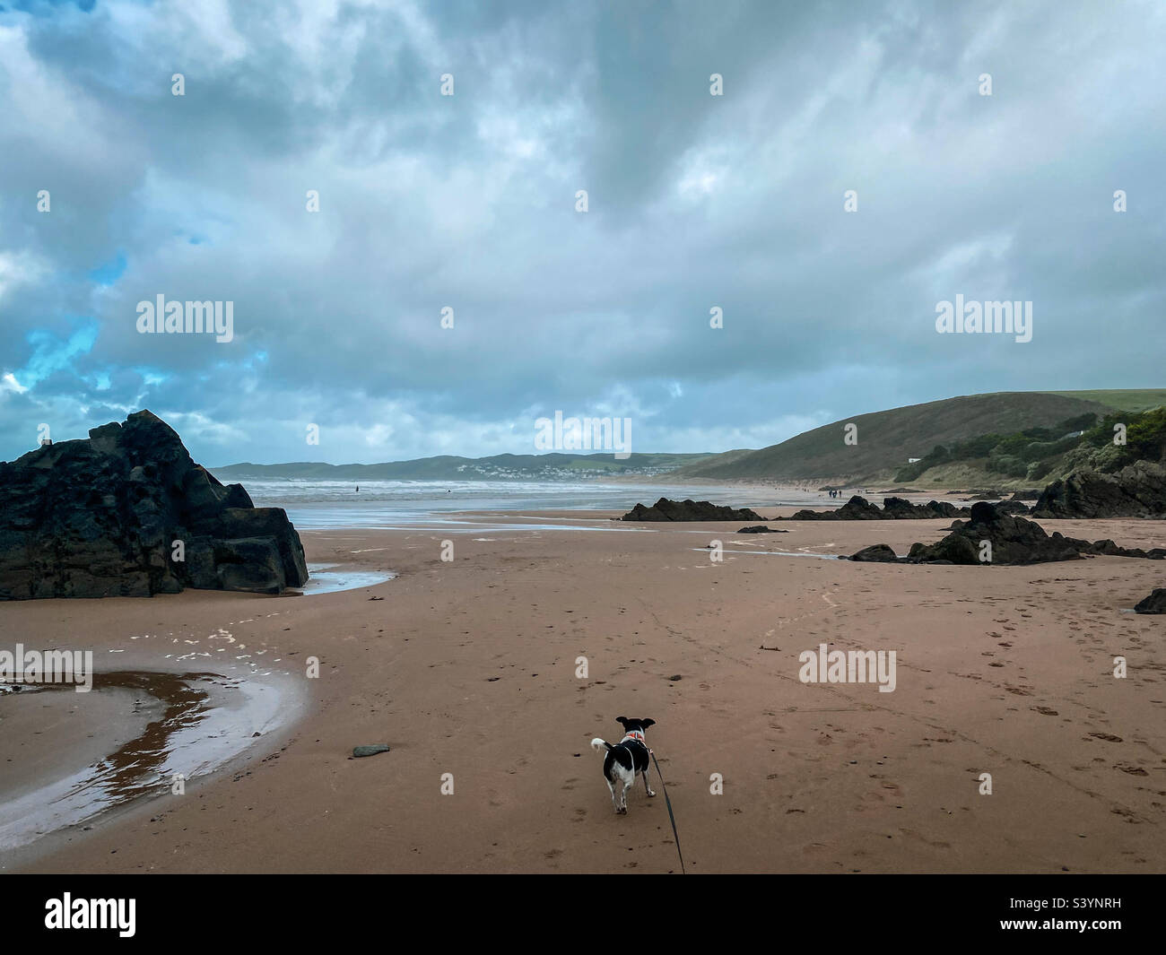 A few visitors enjoy an Autumn walk on Woolacombe beach Stock Photo - Alamy