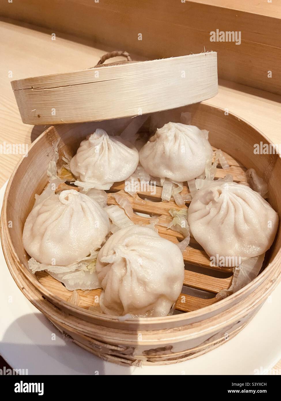 Chinese dumplings inside a bamboo steamer Stock Photo - Alamy