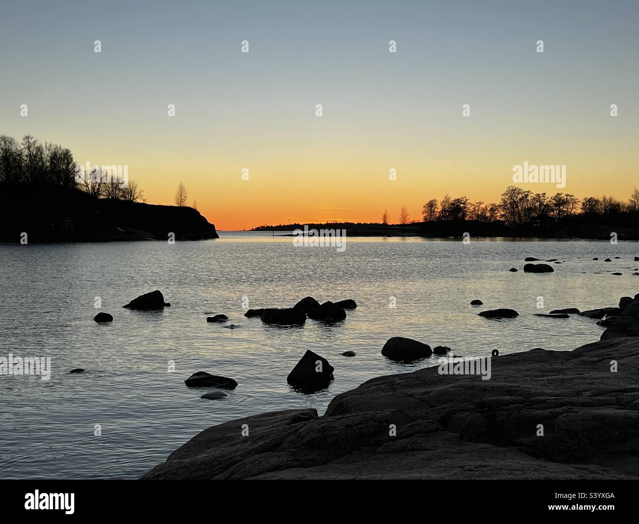 Tranquil sunset view over Golf of Finland in Helsinki with stones in ...