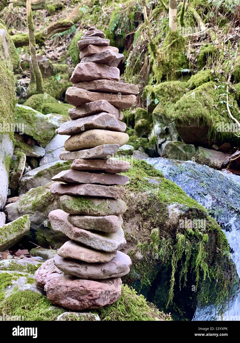 Tower of balancing rocks in artistic stack of flattened stones against ...