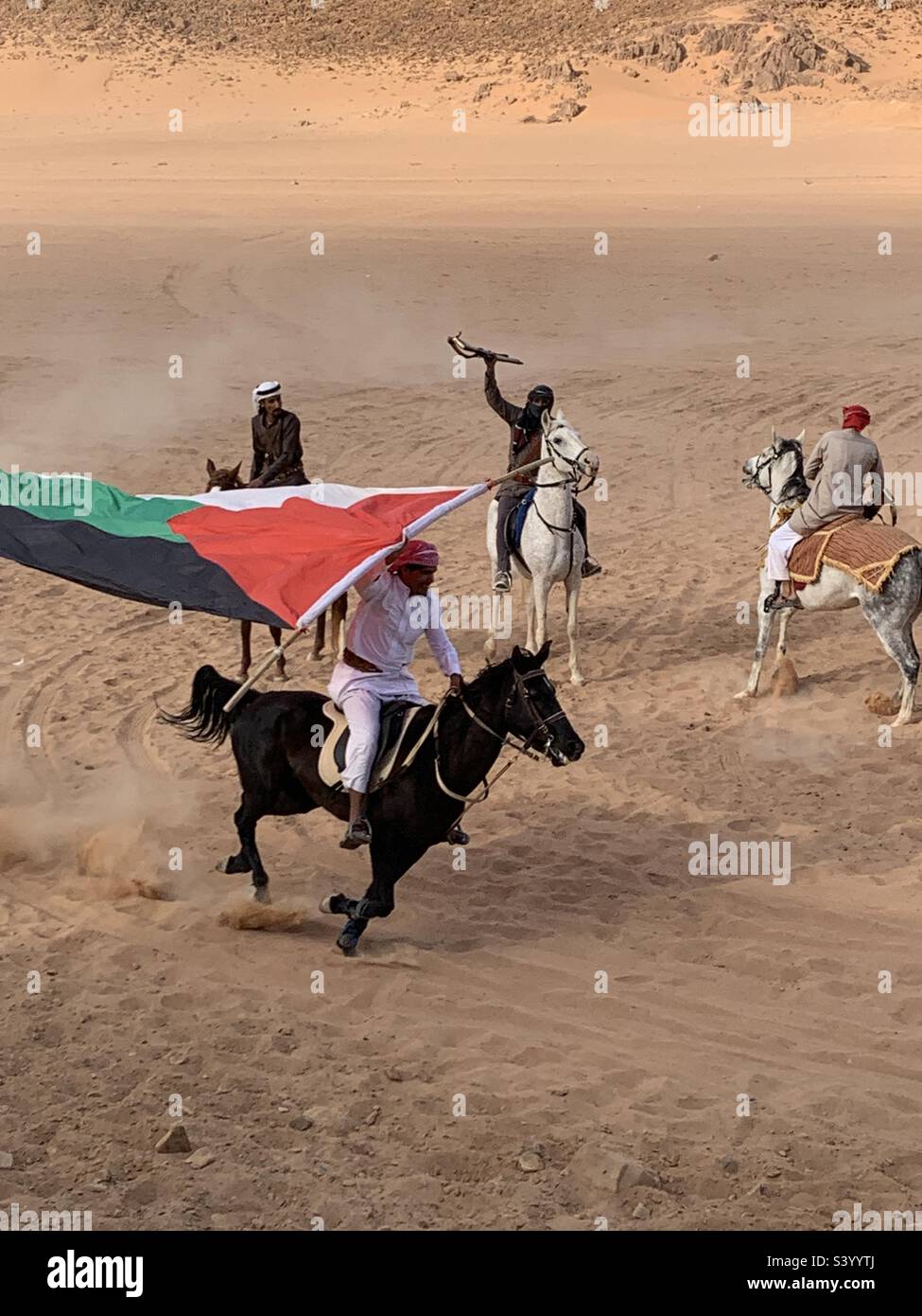 Man on horseback waving Jordan flag Stock Photo - Alamy