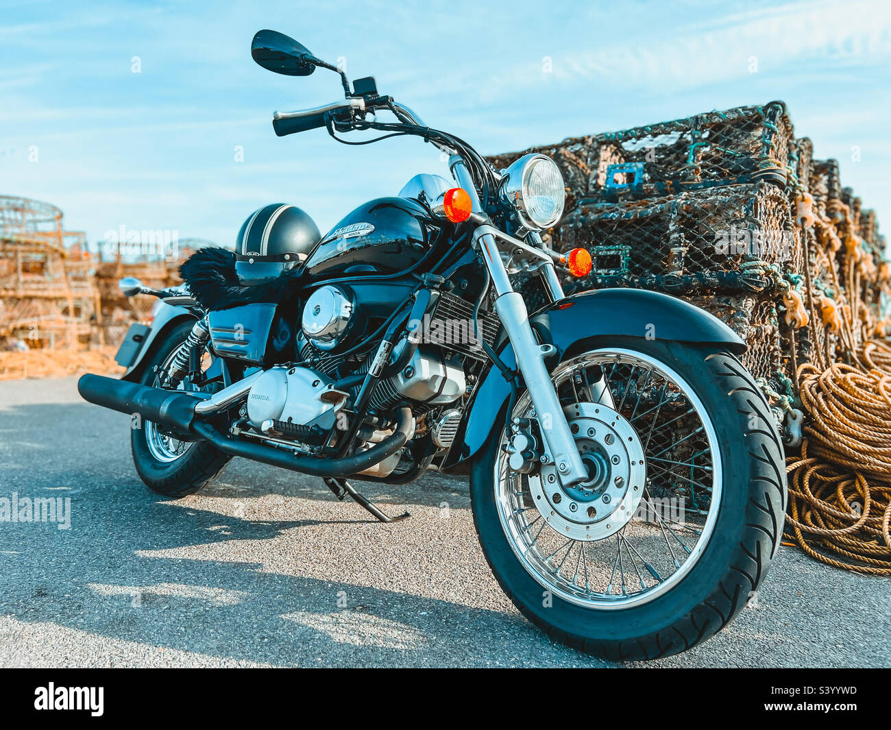 A black Honda Shadow motorbike parked on Mudeford quayside in front of ...