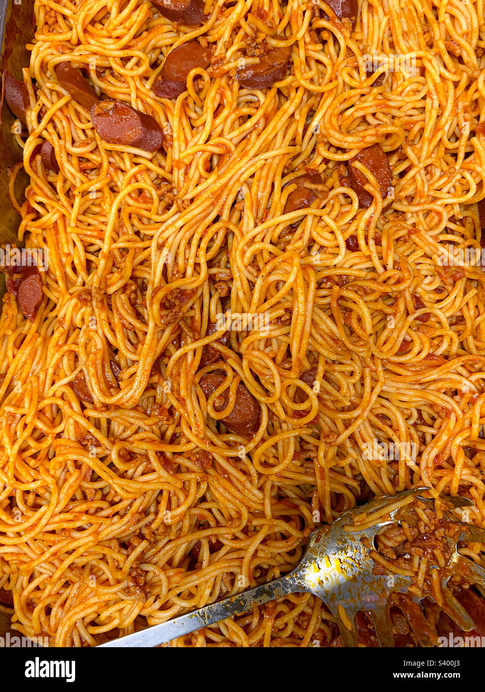 Spaghetti cooked and served in A Filipino style with sliced hotdogs and ...